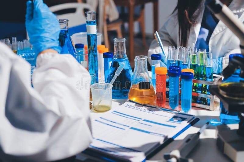 Scientist Pipetting Medical Samples into Microplate in Laboratory Stock ...