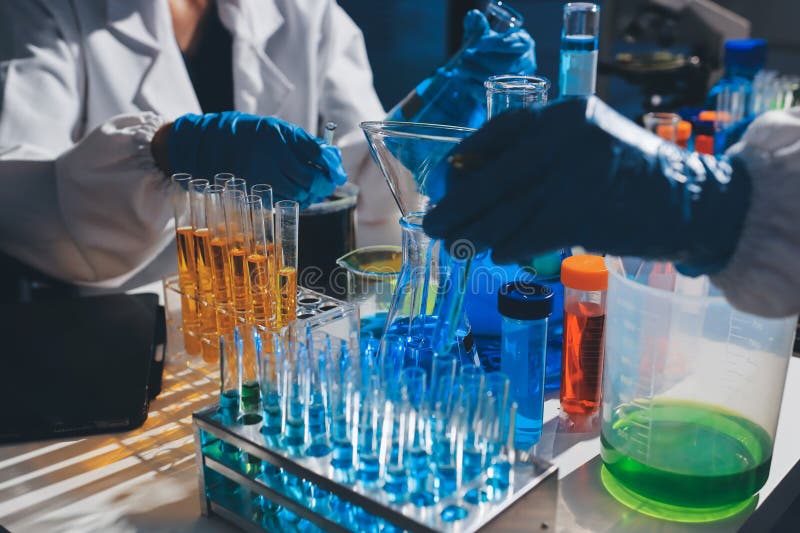 Scientist Pipetting Medical Samples into Microplate in Laboratory Stock ...