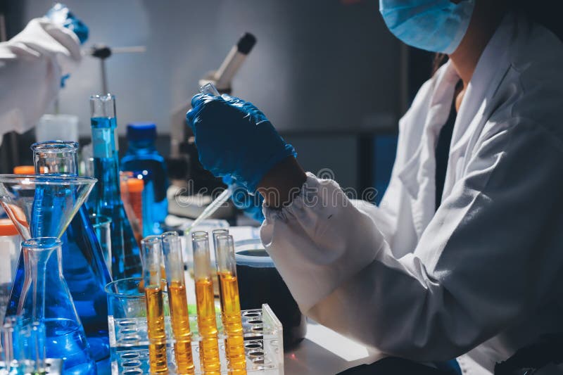 Scientist Pipetting Medical Samples into Microplate in Laboratory Stock ...