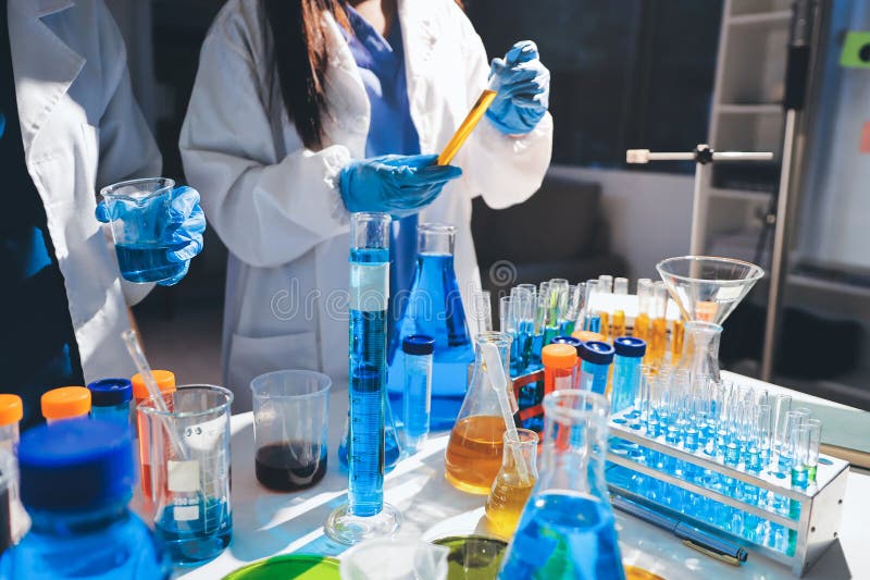 Scientist Pipetting Medical Samples into Microplate in Laboratory Stock ...