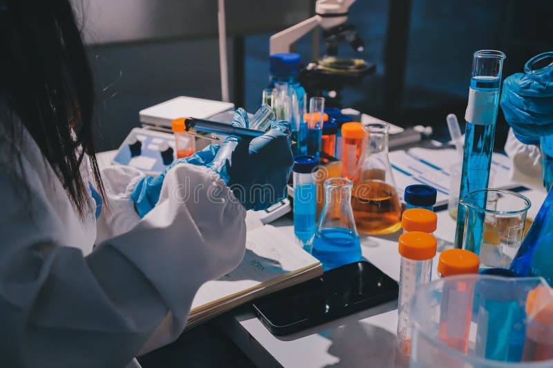 Scientist Pipetting Medical Samples into Microplate in Laboratory Stock ...