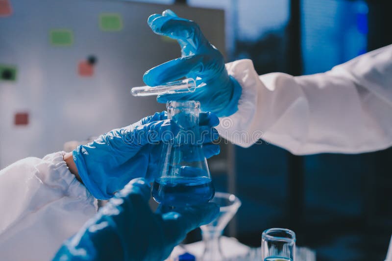 Scientist Pipetting Medical Samples into Microplate in Laboratory Stock ...
