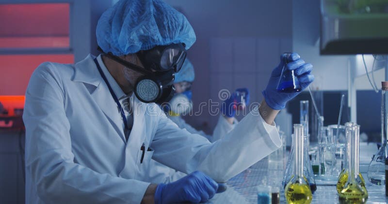 Scientist Pouring Liquid To Conical Flask Stock Image - Image of liquid ...