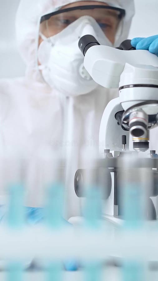 Scientist in Ppe Analyzing Samples with Microscope. Close-up of a ...
