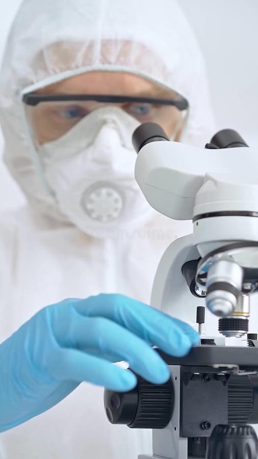 Scientist in Ppe Analyzing Samples and Analyzing Samples with a ...