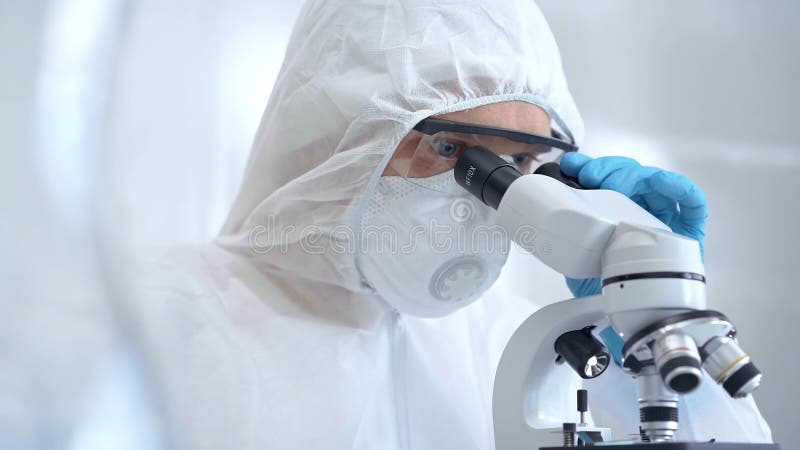 Scientist in Ppe Analyzing Samples Using a Microscope in a Laboratory ...