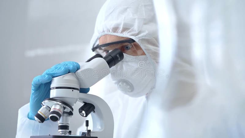 Scientist in Ppe Analyzing Samples Using a Microscope in a Laboratory ...