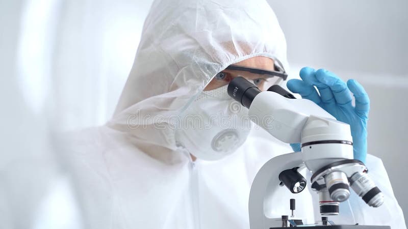 Scientist in Ppe Analyzing Samples Using a Microscope in a Laboratory ...