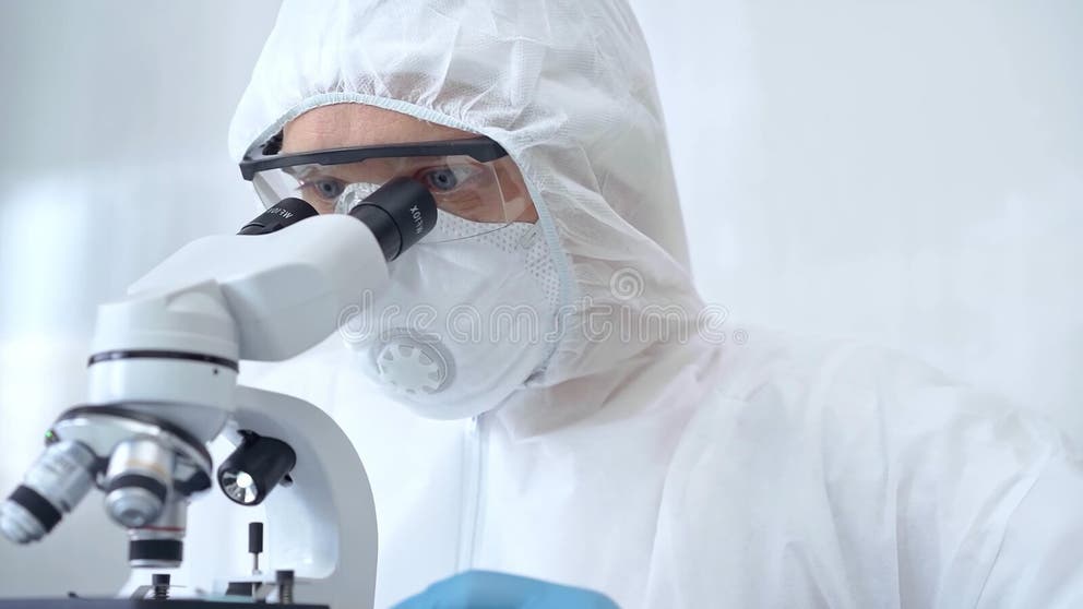 Scientist in Ppe Analyzing Samples Using a Microscope in a Laboratory ...