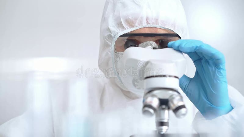 Scientist in Ppe Analyzing Samples Using a Microscope in a Laboratory Setting Stock Video ...