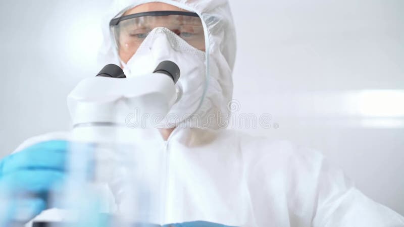 Scientist in Ppe Analyzing Samples Using a Microscope in a Laboratory Setting Stock Video ...