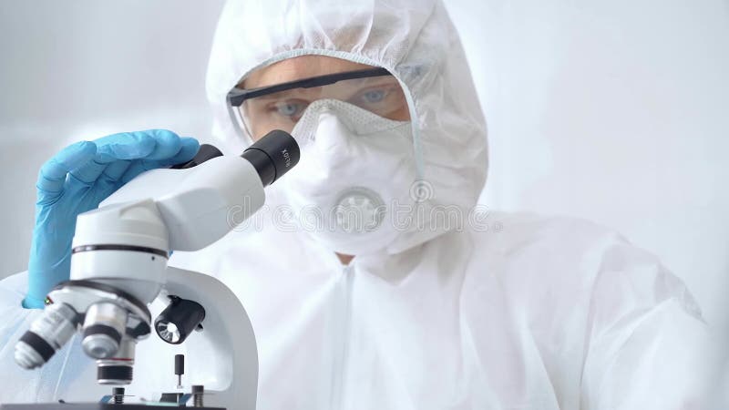 Scientist in Ppe Analyzing Samples Using a Microscope in a Laboratory ...