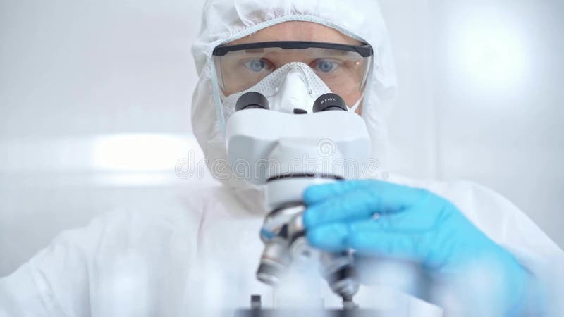 Scientist in Ppe Analyzing Samples Using a Microscope in a Laboratory Setting Stock Footage ...