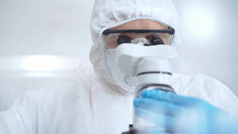 Scientist in Ppe Analyzing Samples Using a Microscope in a Laboratory Setting Stock Video ...