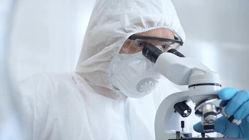 Scientist in Ppe Analyzing Samples Using a Microscope in a Laboratory Setting Stock Video ...