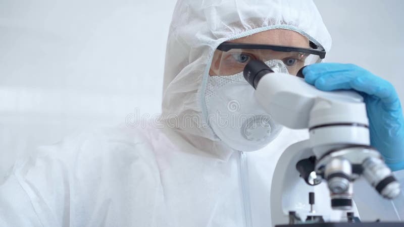 Scientist in Ppe Analyzing Samples Using a Microscope in a Laboratory ...