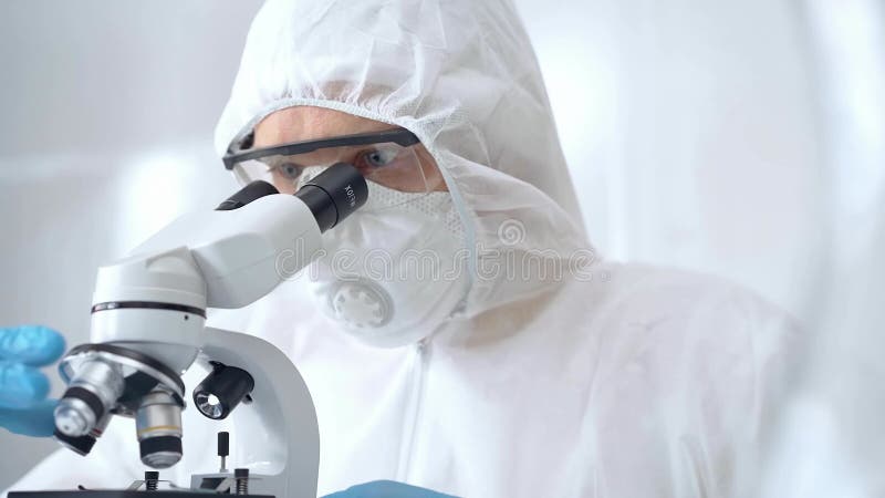 Scientist in Ppe Analyzing Samples Using a Microscope in a Laboratory Setting Stock Video ...