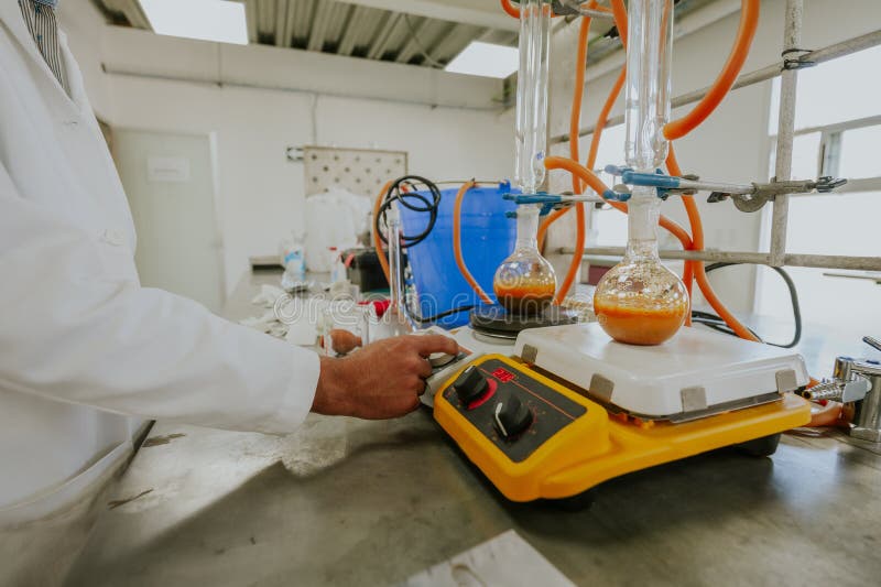 Scientist Preparing Solutions and Analyzing the Results of Chemical ...