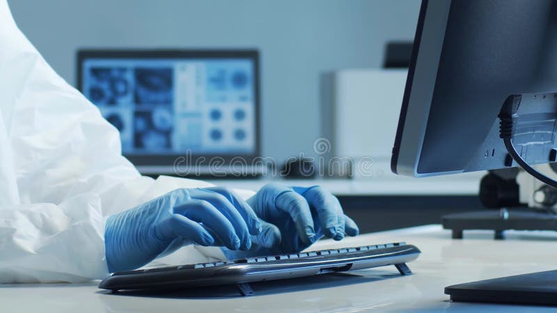 Scientist in Protection Suit and Masks Working in Research Lab Using ...