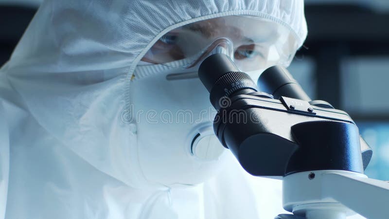 Scientist in Protection Suit and Masks Working in Research Lab Using ...