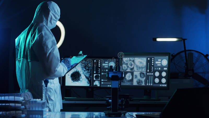 Scientist in Protection Suit and Masks Working in Research Lab Using ...