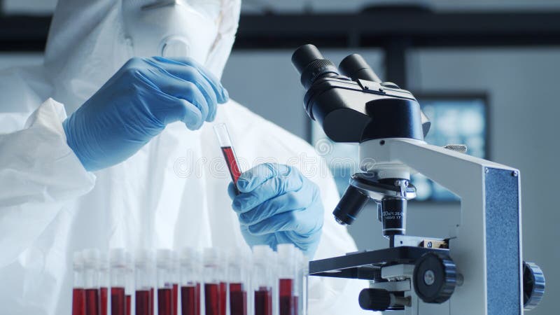 Scientist in Protection Suit and Masks Working in Research Lab Using ...