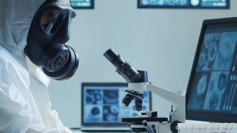 Scientist in Protection Suit and Masks Working in Research Lab Using ...
