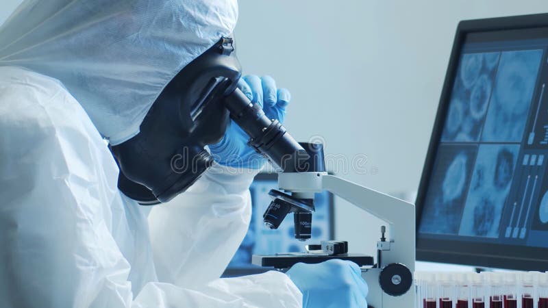Scientist in Protection Suit and Masks Working in Research Lab Using ...