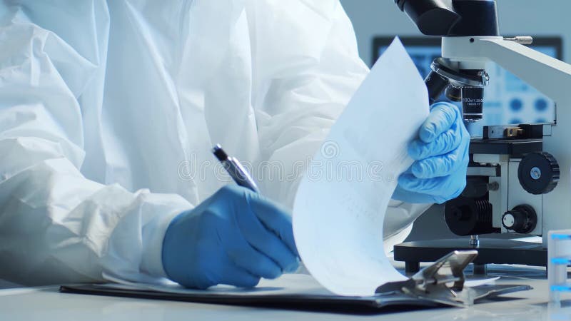 Scientist in Protection Suit and Masks Working in Research Lab Using ...