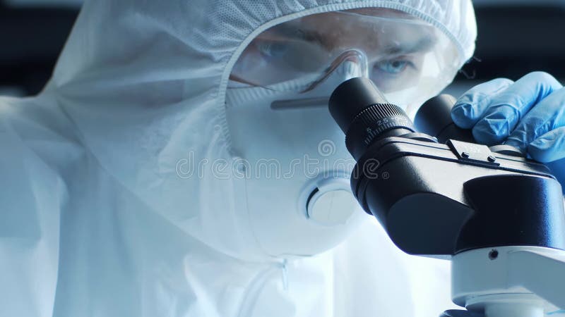 Scientist in Protection Suit and Masks Working in Research Lab Using ...