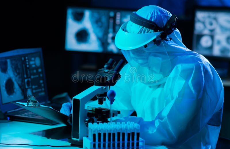 Scientist in Protection Suits and Masks Working in Research Lab Using ...