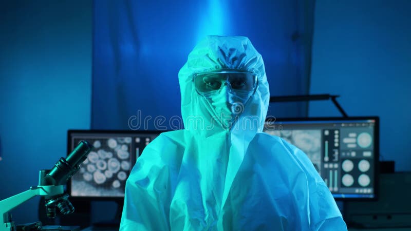 Scientist in Protection Suits and Masks Working in Research Lab Using ...
