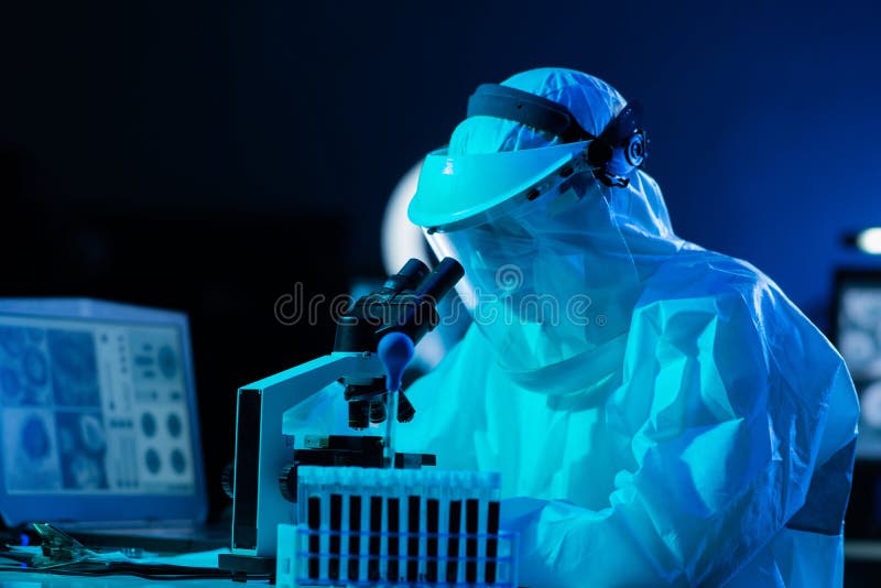 Scientist in Protection Suits and Masks Working in Research Lab Using ...