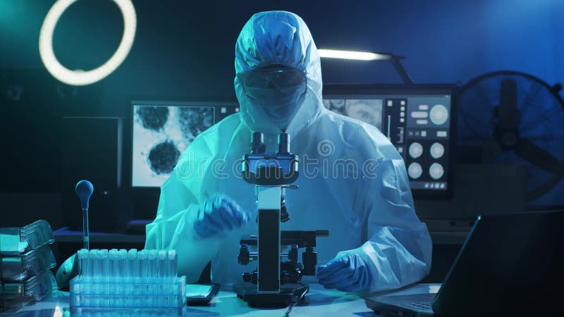 Scientist in Protection Suit and Masks Working in Research Lab Using ...