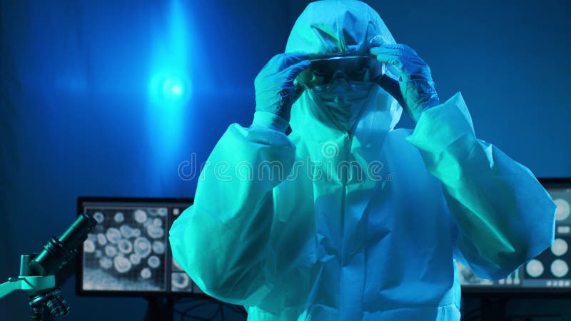Scientist in Protection Suit and Masks Working in Research Lab Using ...