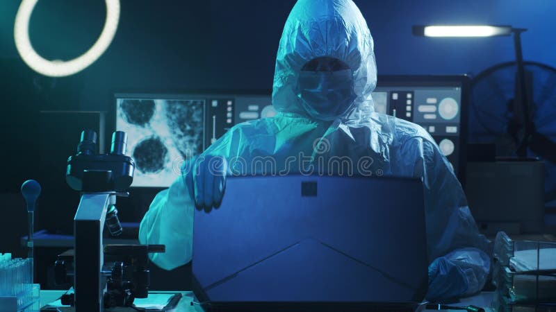 Scientist in Protection Suits and Masks Working in Research Lab Using ...