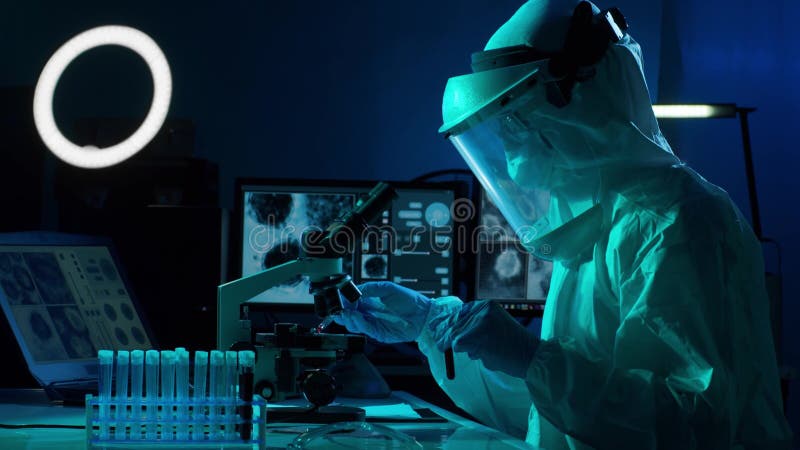 Scientist in Protection Suits and Masks Working in Research Lab Using ...