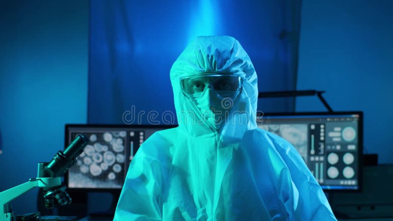 Scientist in Protection Suits and Masks Working in Research Lab Using ...