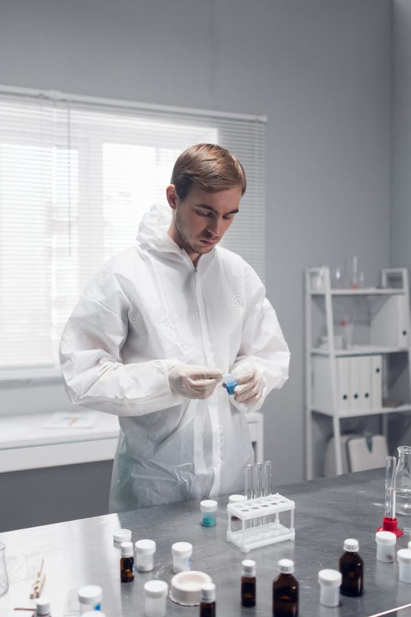 A Scientist in Protective Clothing Standing at the Table in the Science ...