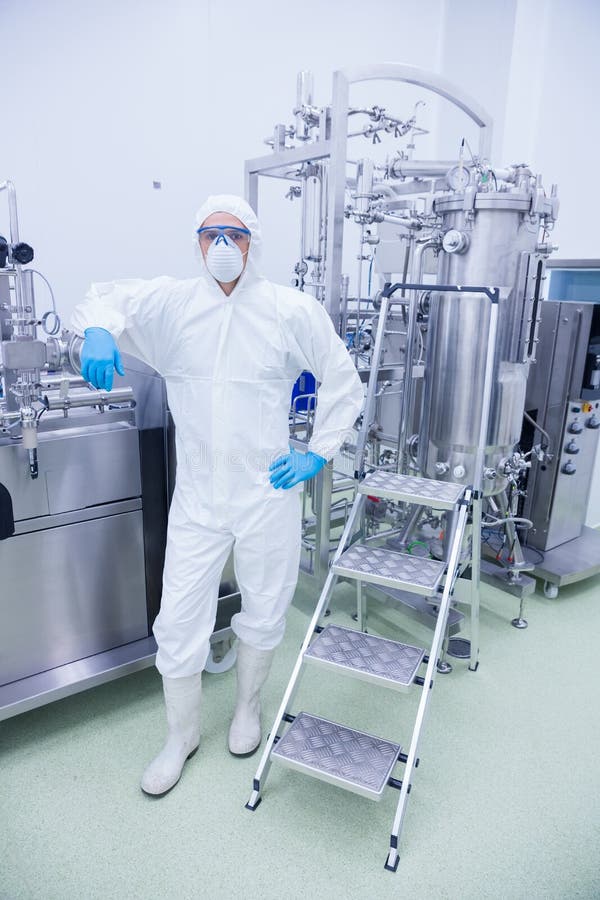 Scientist in Protective Suit Leaning Against Machine Stock Photo ...