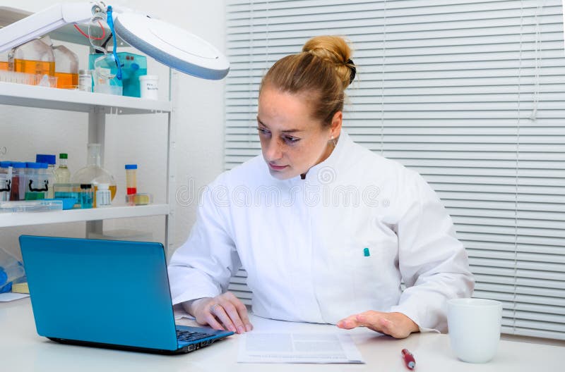 Scientist Reads Papers on Computer in the Lab Stock Photo - Image of ...