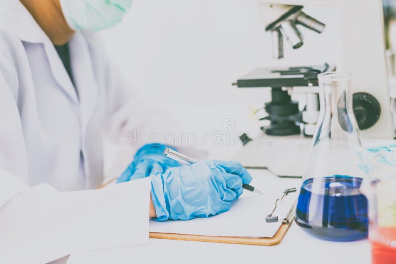 The Scientist is Recording the Scientific Value on a Note. in an ...