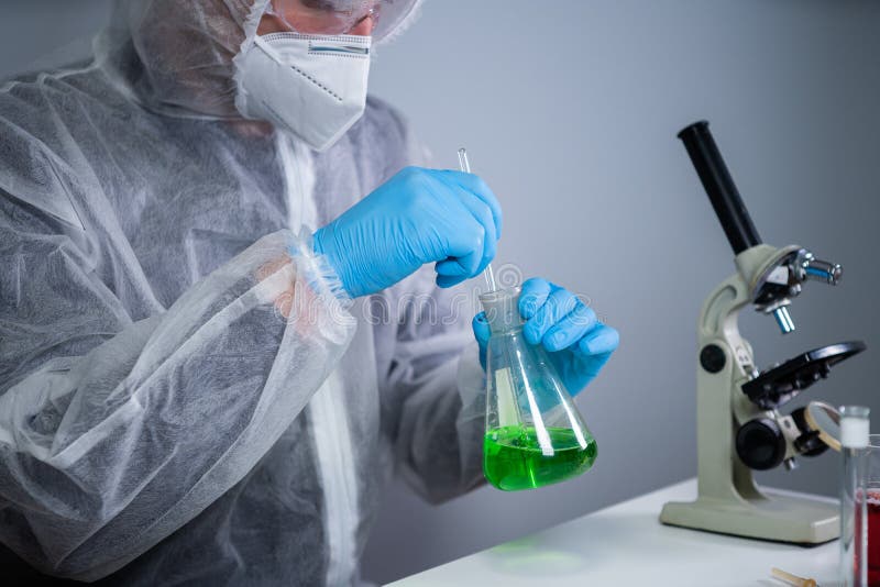 Scientist Shaking Green Fluid in Beaker. Young Laboratory Assistant ...
