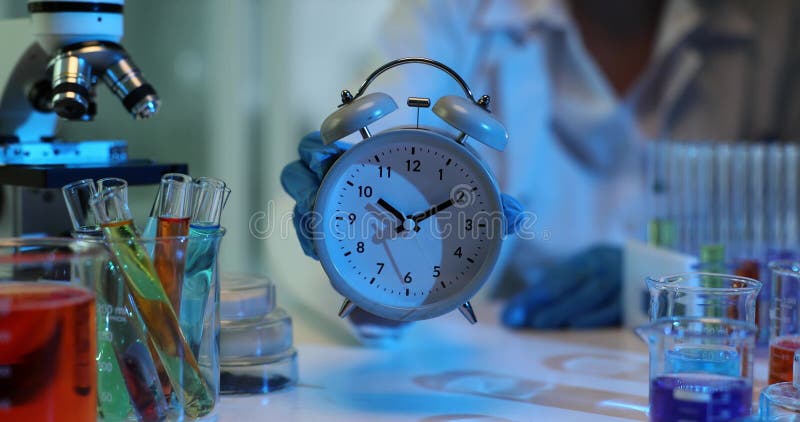 Scientist Shows Alarm Clock Setting Start Time for Research Stock ...