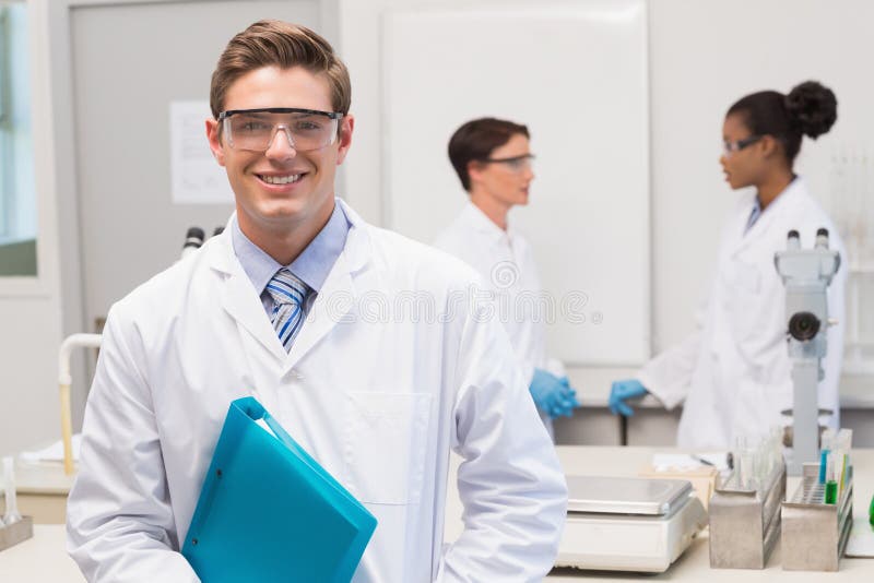 Scientist Smiling at Camera while Colleagues Talking Together Stock ...