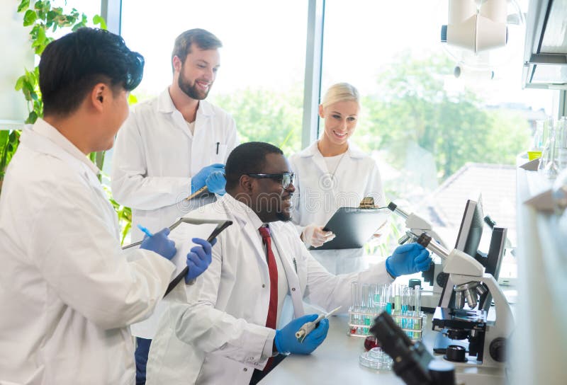 Scientist and Students Working in Lab. Doctor Teaching Interns To Make ...