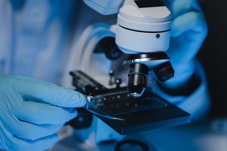 A Scientist is Studying Samples Using a Microscope To Study and Develop ...