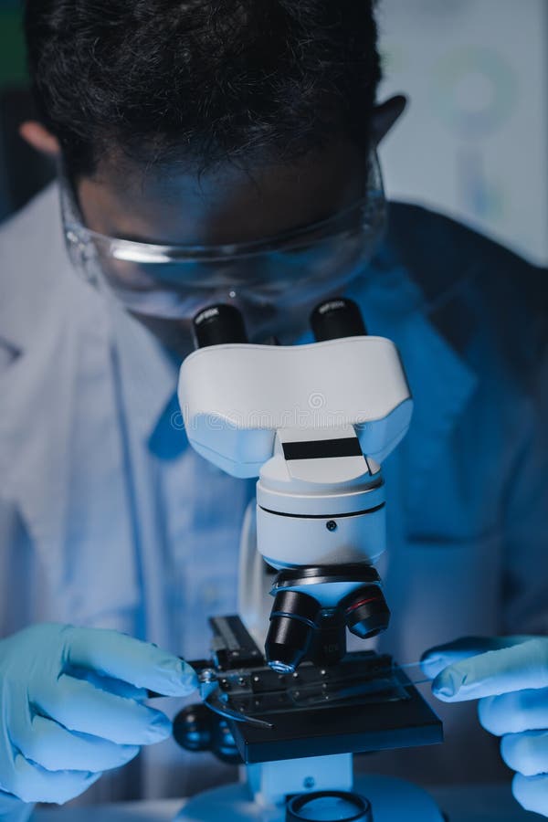 A Scientist is Studying Samples Using a Microscope To Study and Develop ...