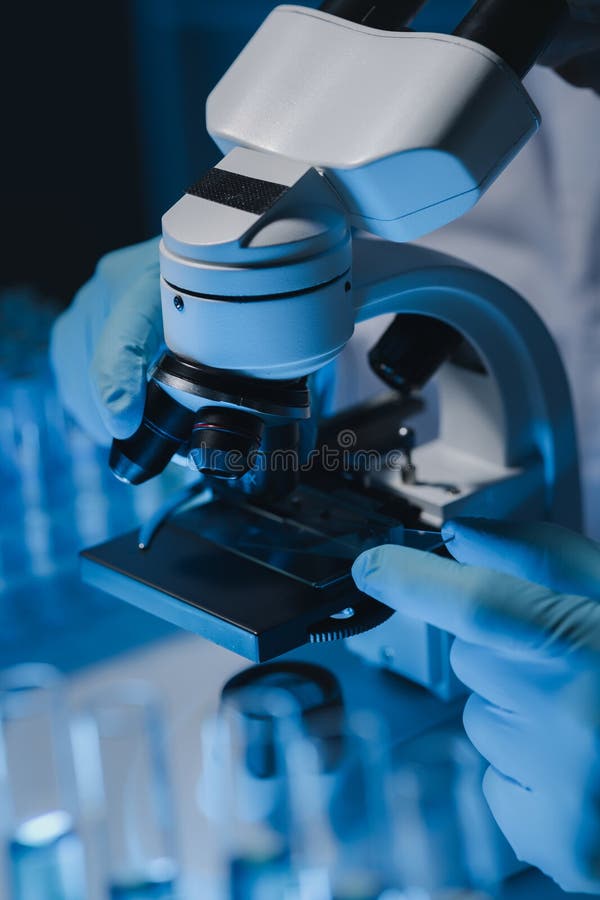 A Scientist is Studying Samples Using a Microscope To Study and Develop the Field of ...