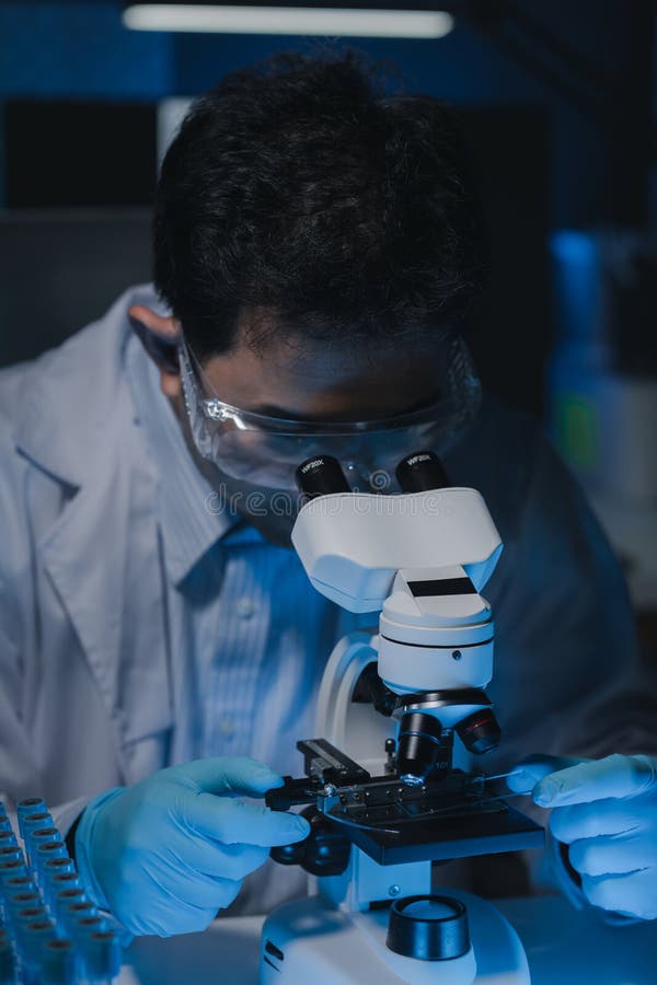 A Scientist is Studying Samples Using a Microscope To Study and Develop the Field of ...